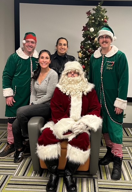In the photo of Santa and the Elves, above, are, from left, Firefighter ...